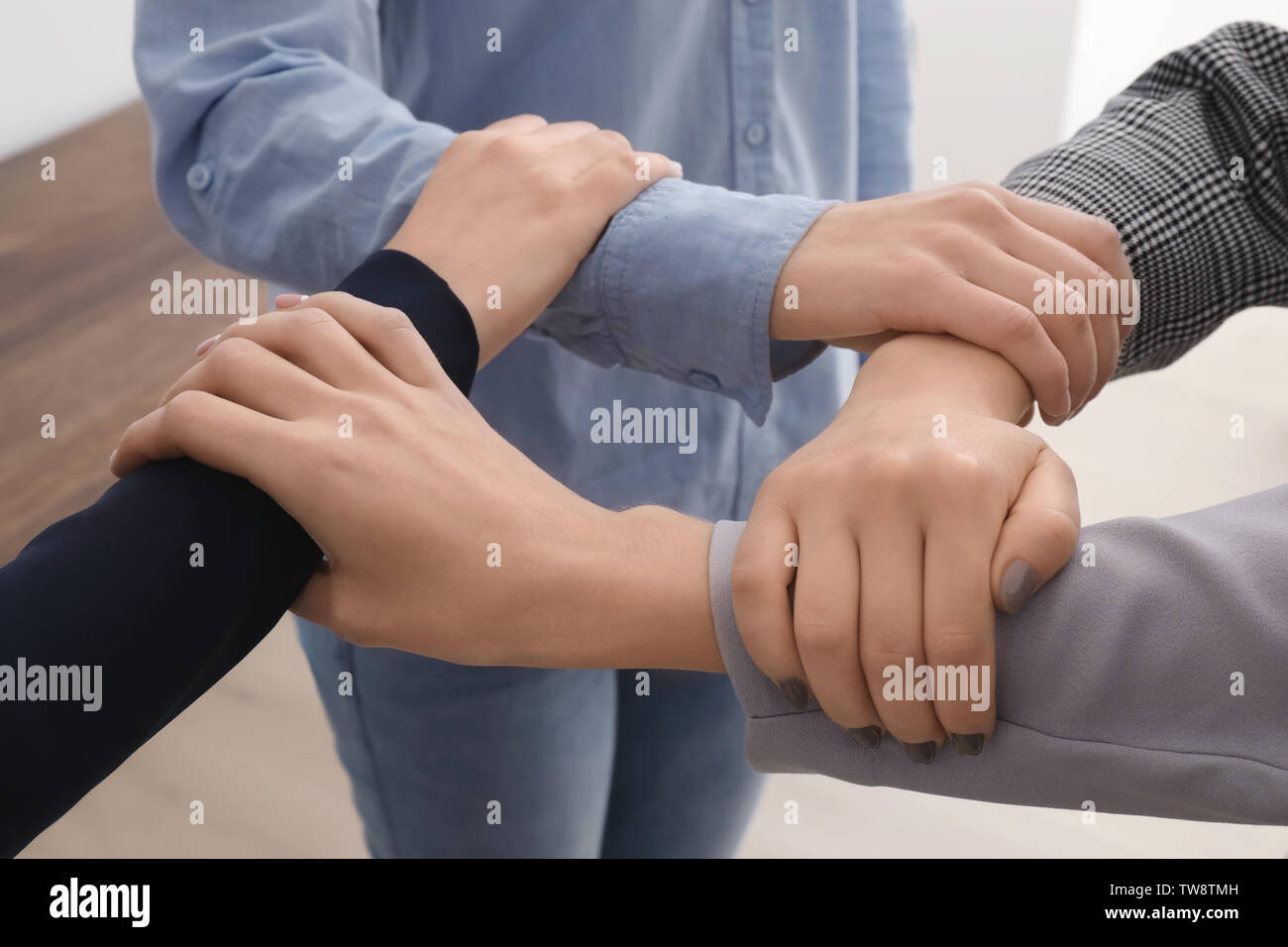 People putting hands together as symbol of unity Stock Photo - Alamy