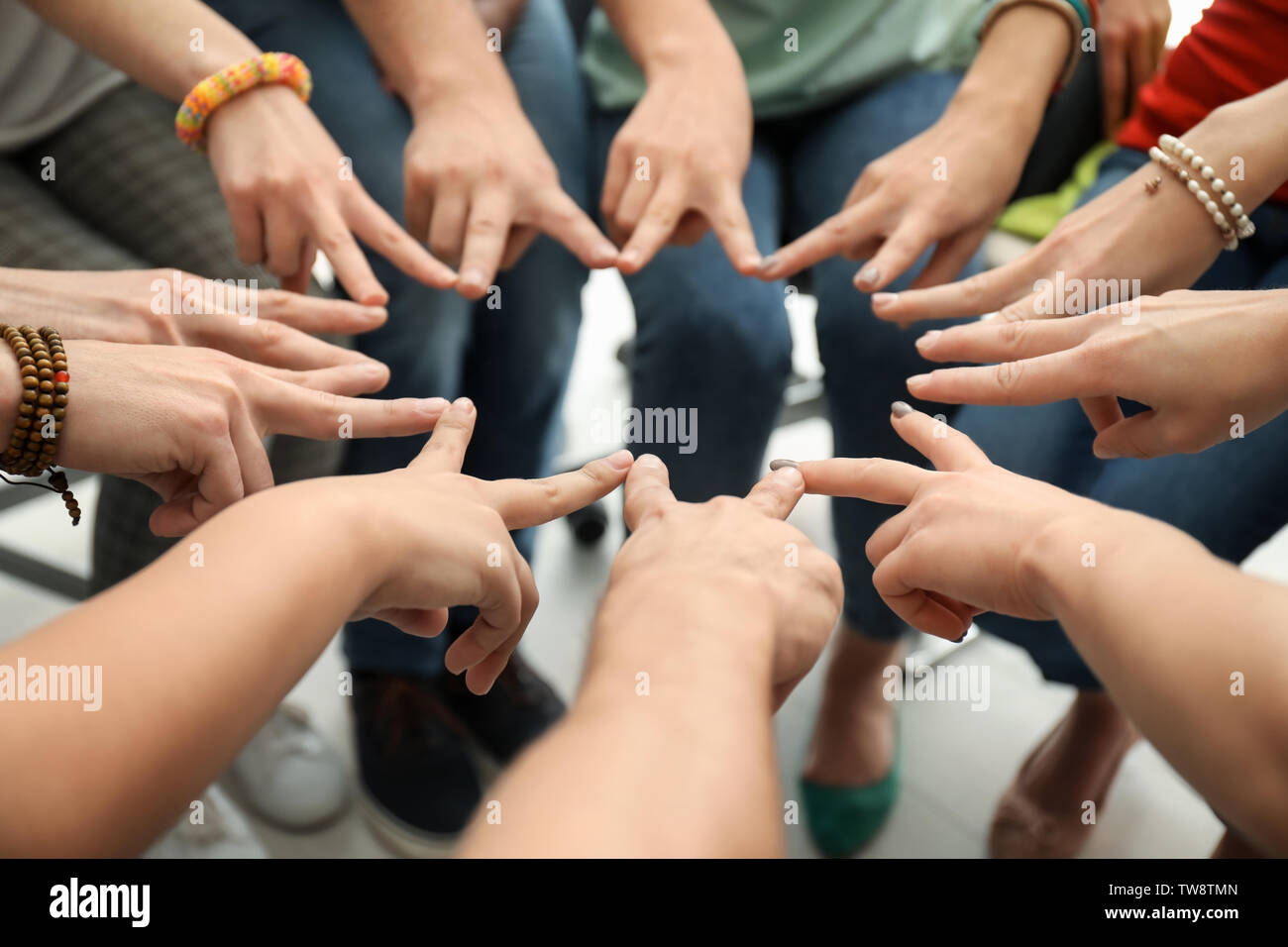 People putting hands together as symbol of unity Stock Photo - Alamy