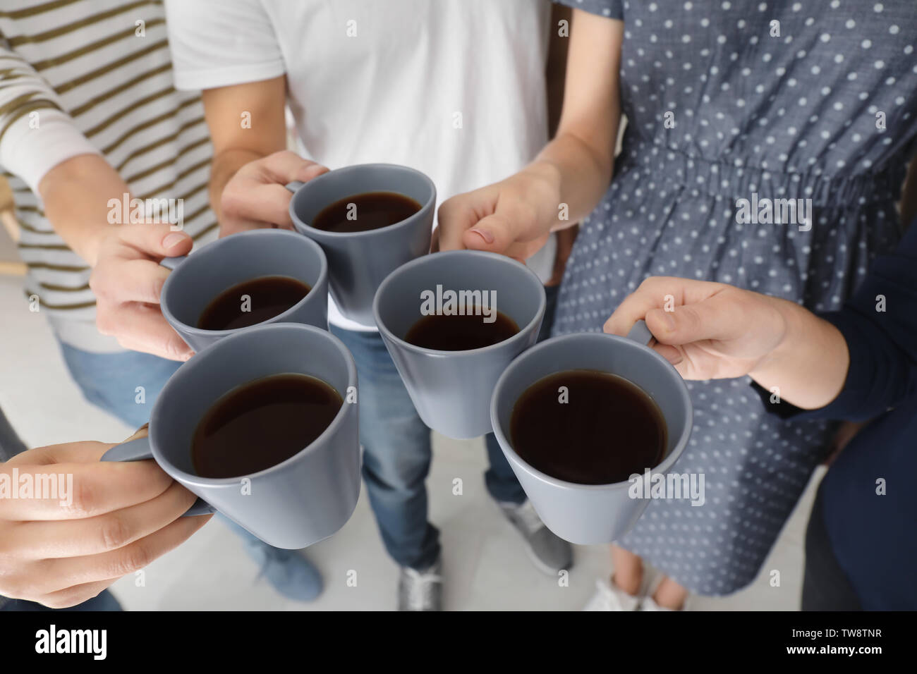 People holding cups of coffee together. Unity concept Stock Photo - Alamy