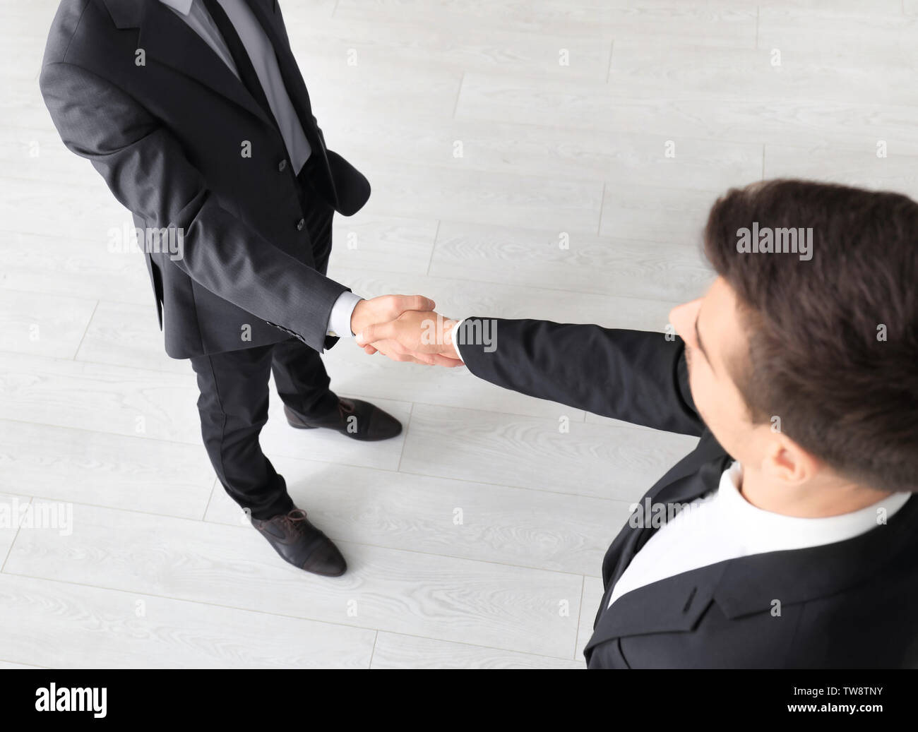 Two man shaking hands as symbol of unity Stock Photo - Alamy