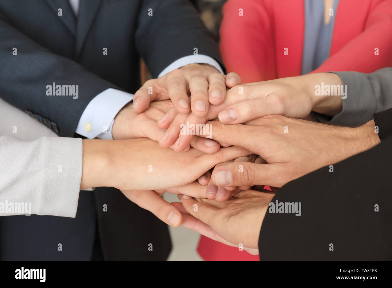 Workers putting hands together hi-res stock photography and images - Alamy