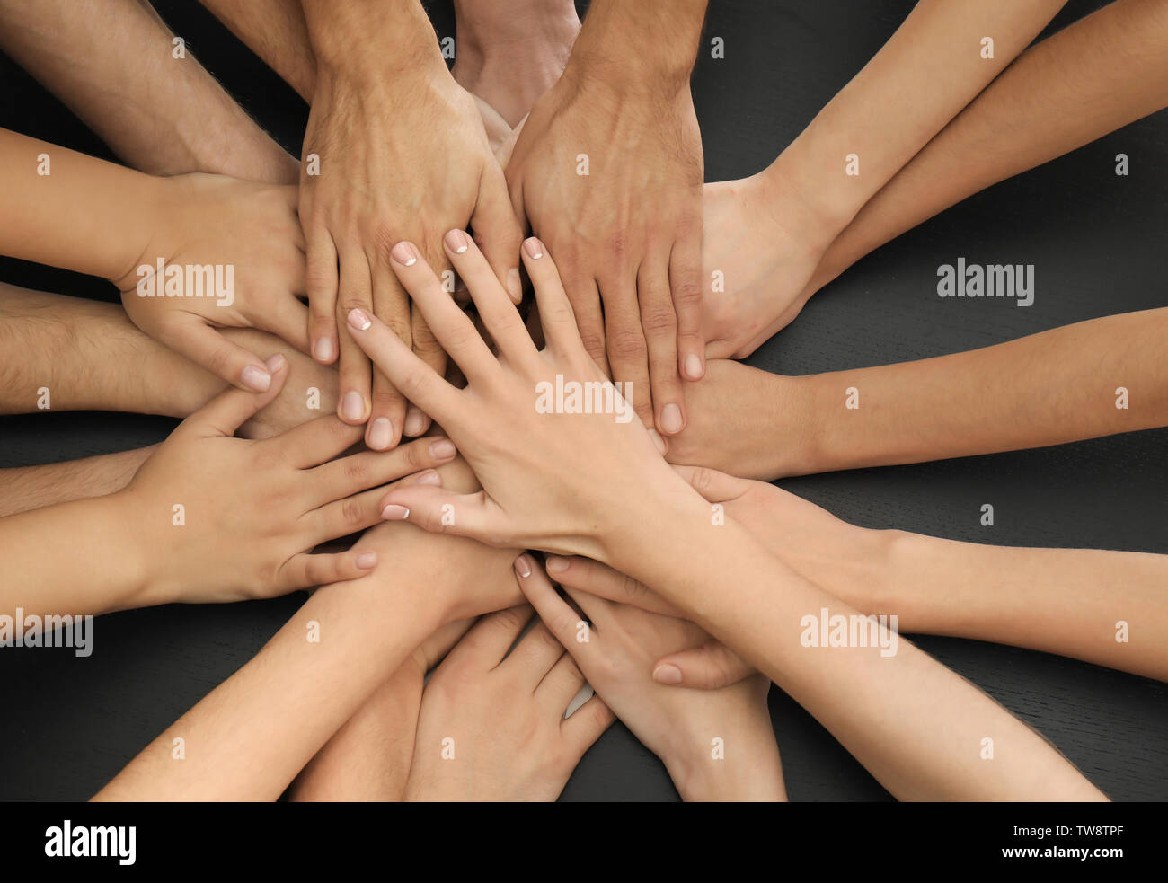 Group of people putting hands together as symbol of unity Stock Photo ...