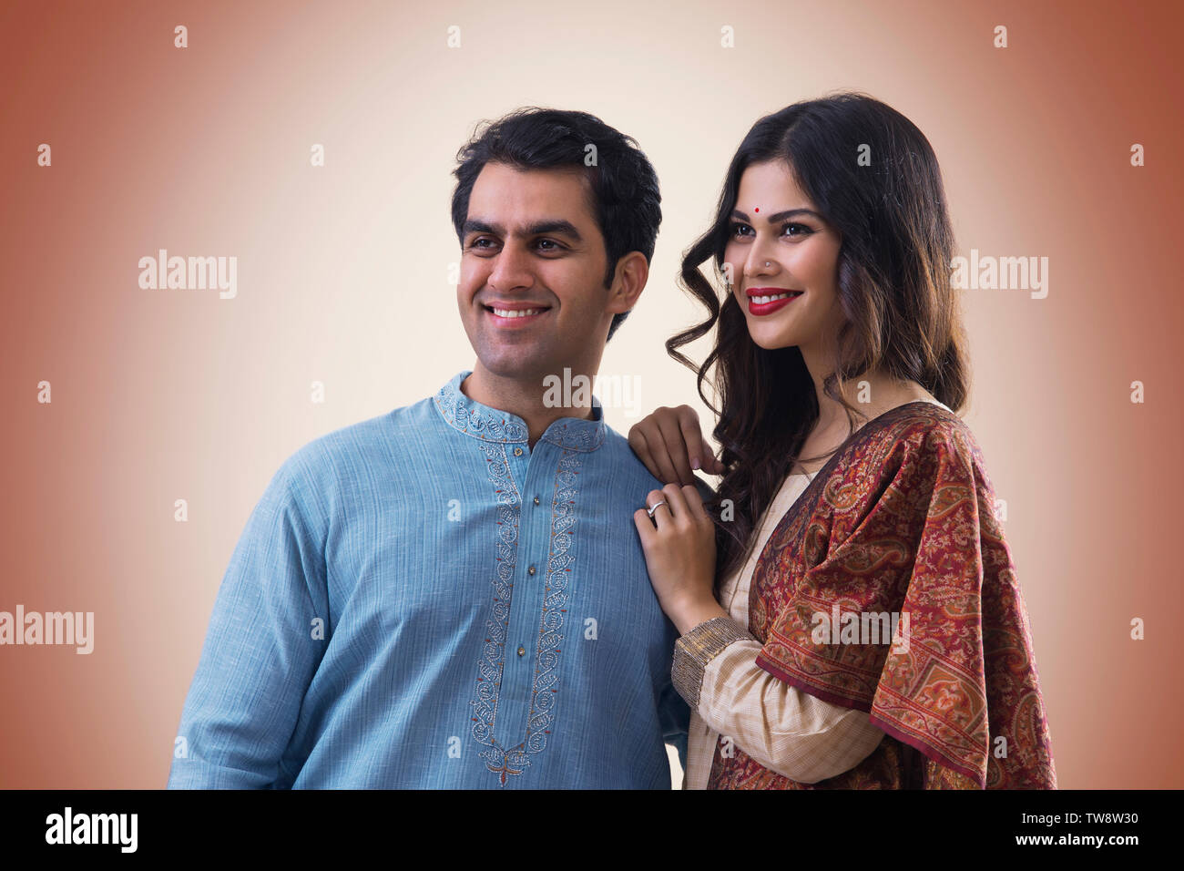 Portrait of smiling young couple in traditional dress Stock Photo - Alamy