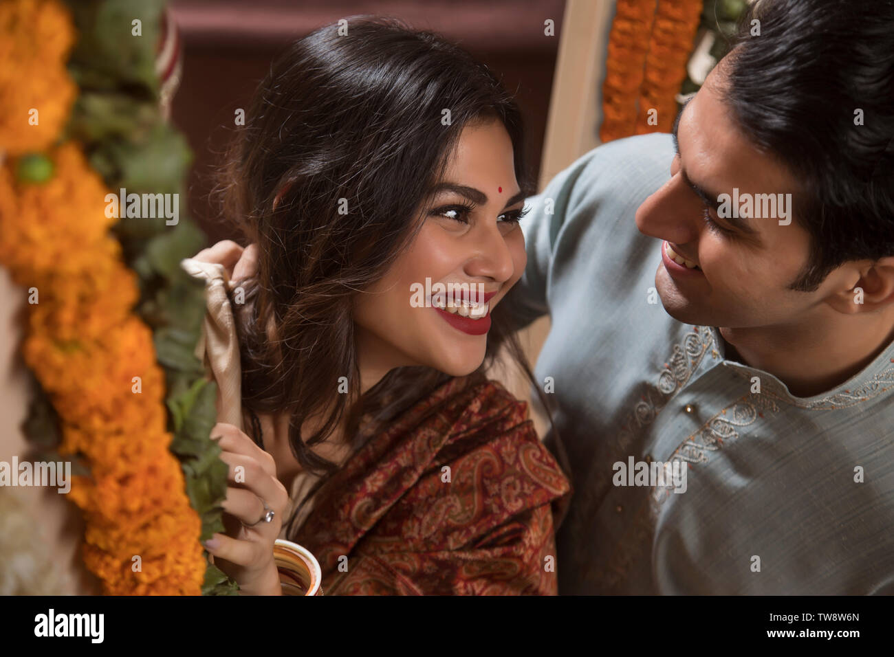 Young couple newlywed in traditional dress performing rituals Stock ...