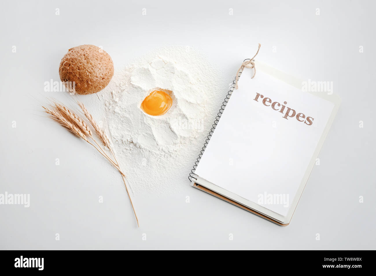 Notebook, flour with egg for bread and bun on white background Stock ...