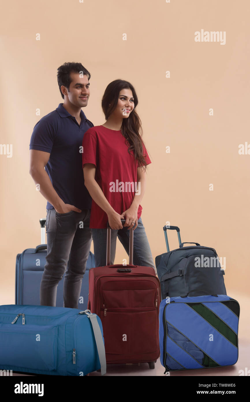 Young couple with luggage at airport Stock Photo - Alamy
