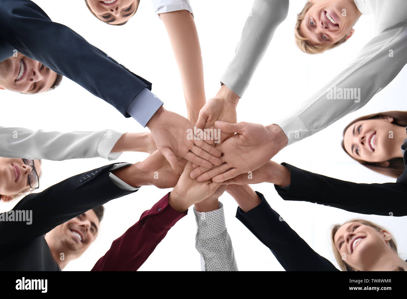 People putting hands together against white background. Unity concept ...