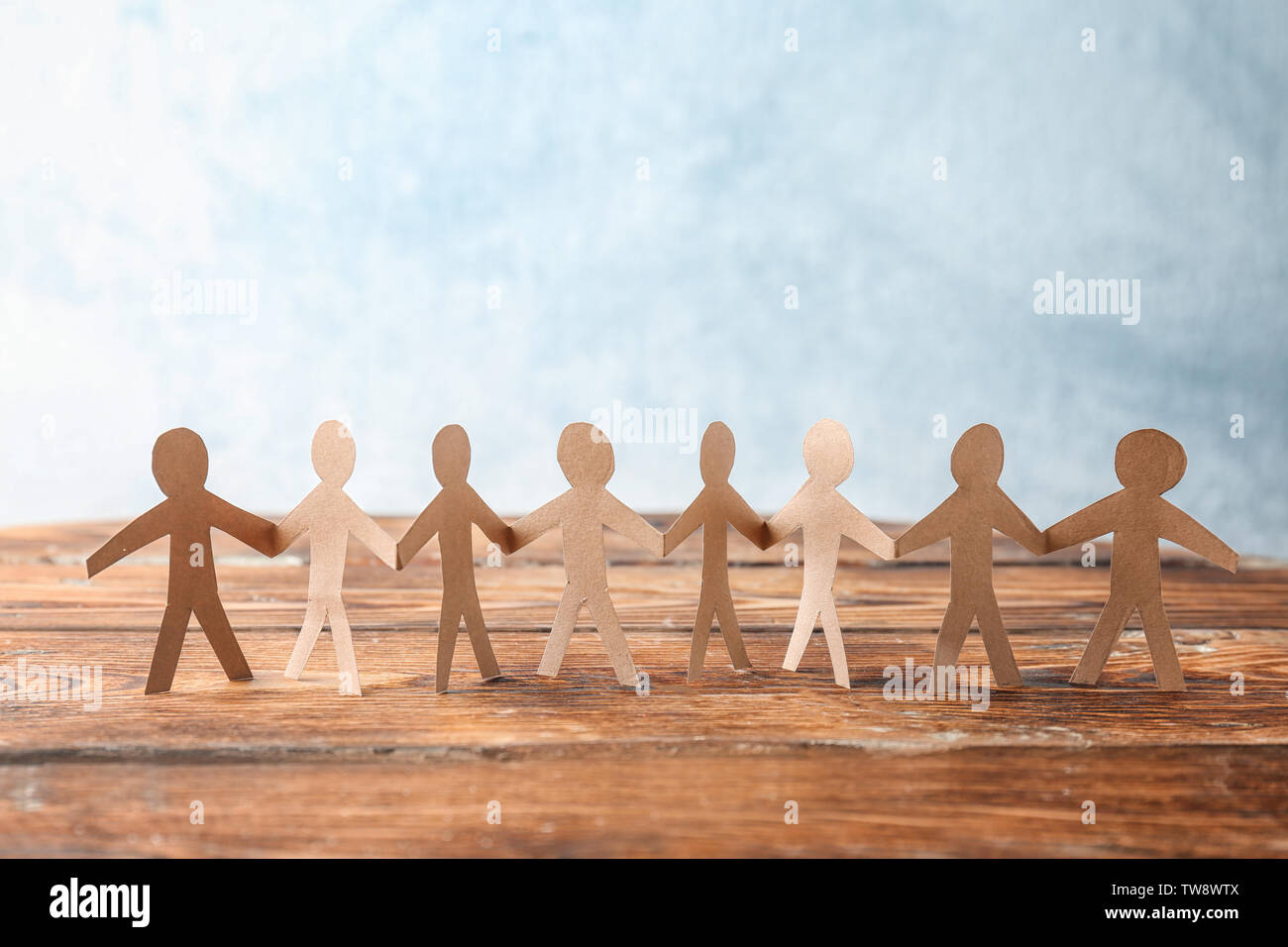 Paper people on light background. Unity concept Stock Photo - Alamy