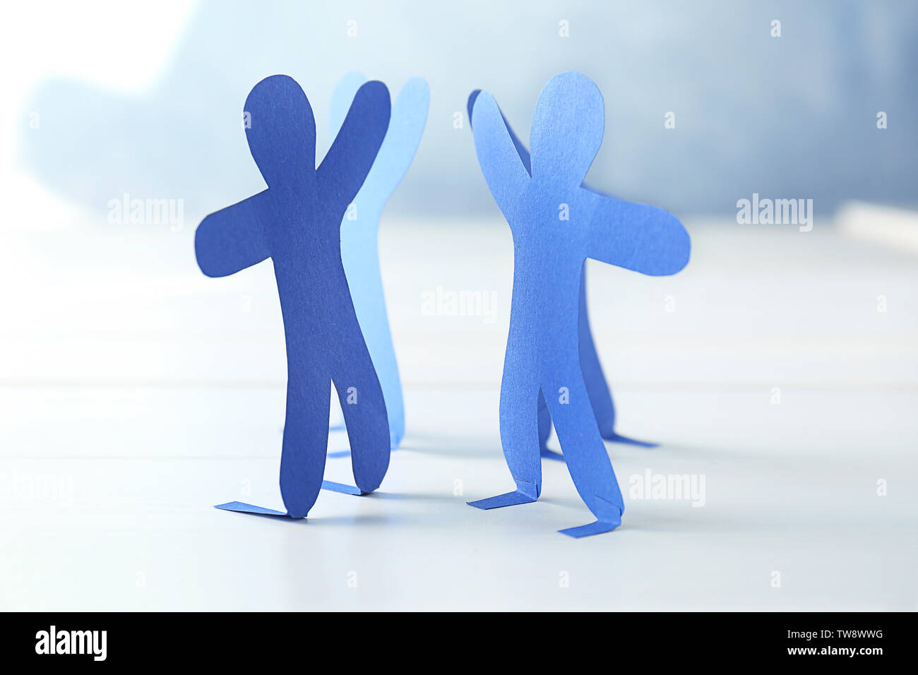 Paper people on light background. Unity concept Stock Photo - Alamy