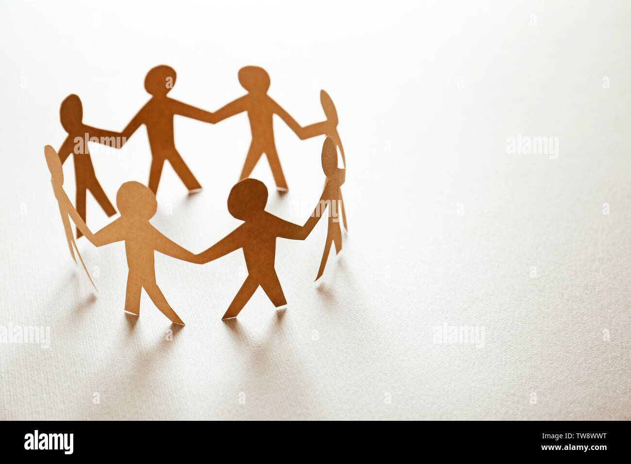 Paper people on light background. Unity concept Stock Photo - Alamy