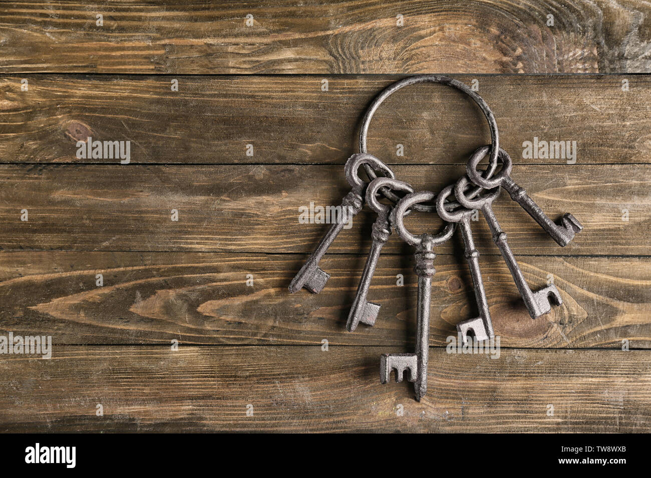 Bunch of keys on wooden background. Unity concept Stock Photo - Alamy