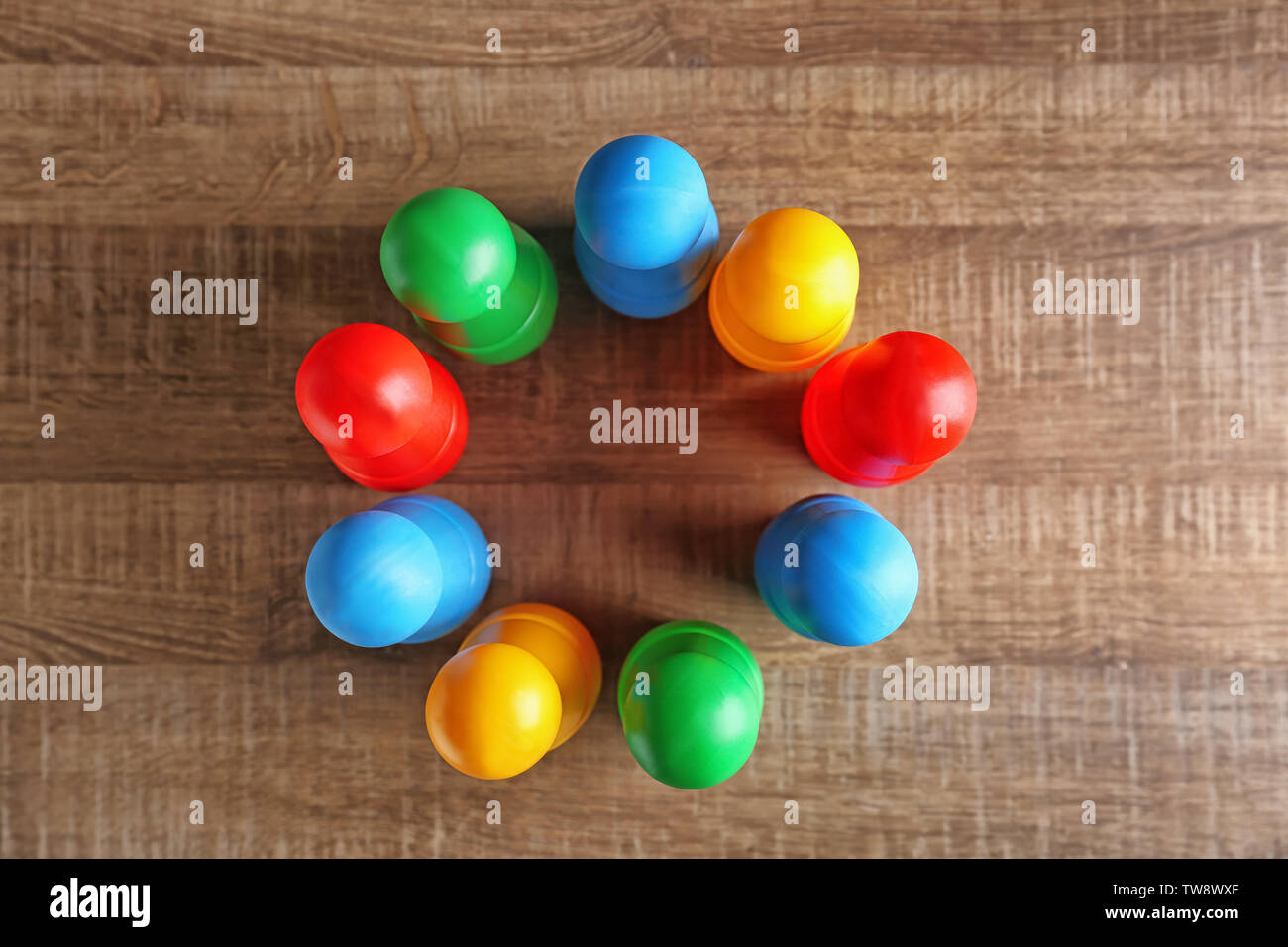 Color pawns on wooden background. Unity concept Stock Photo - Alamy