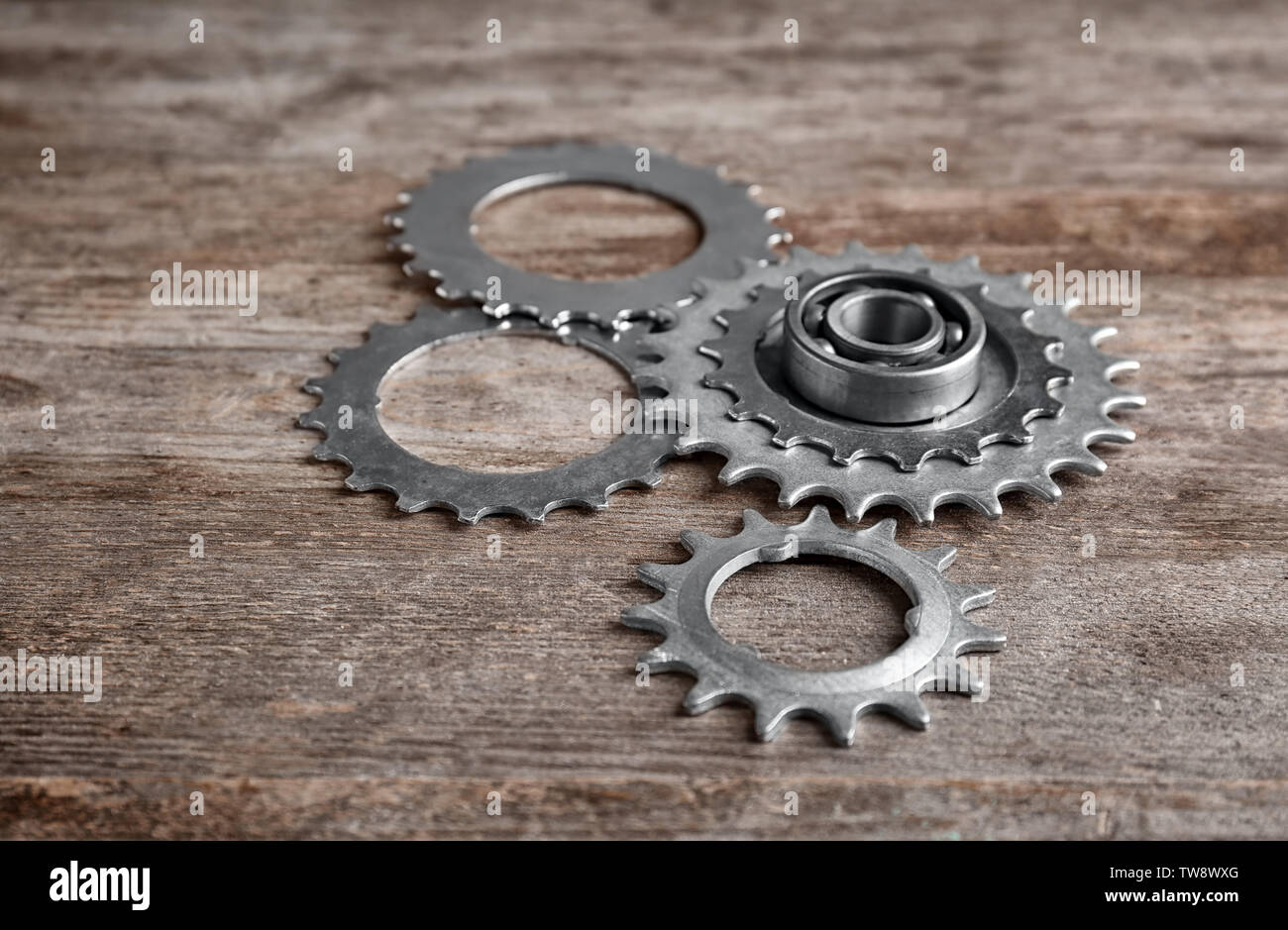 Metal gears assembled in one mechanism on wooden background. Unity ...