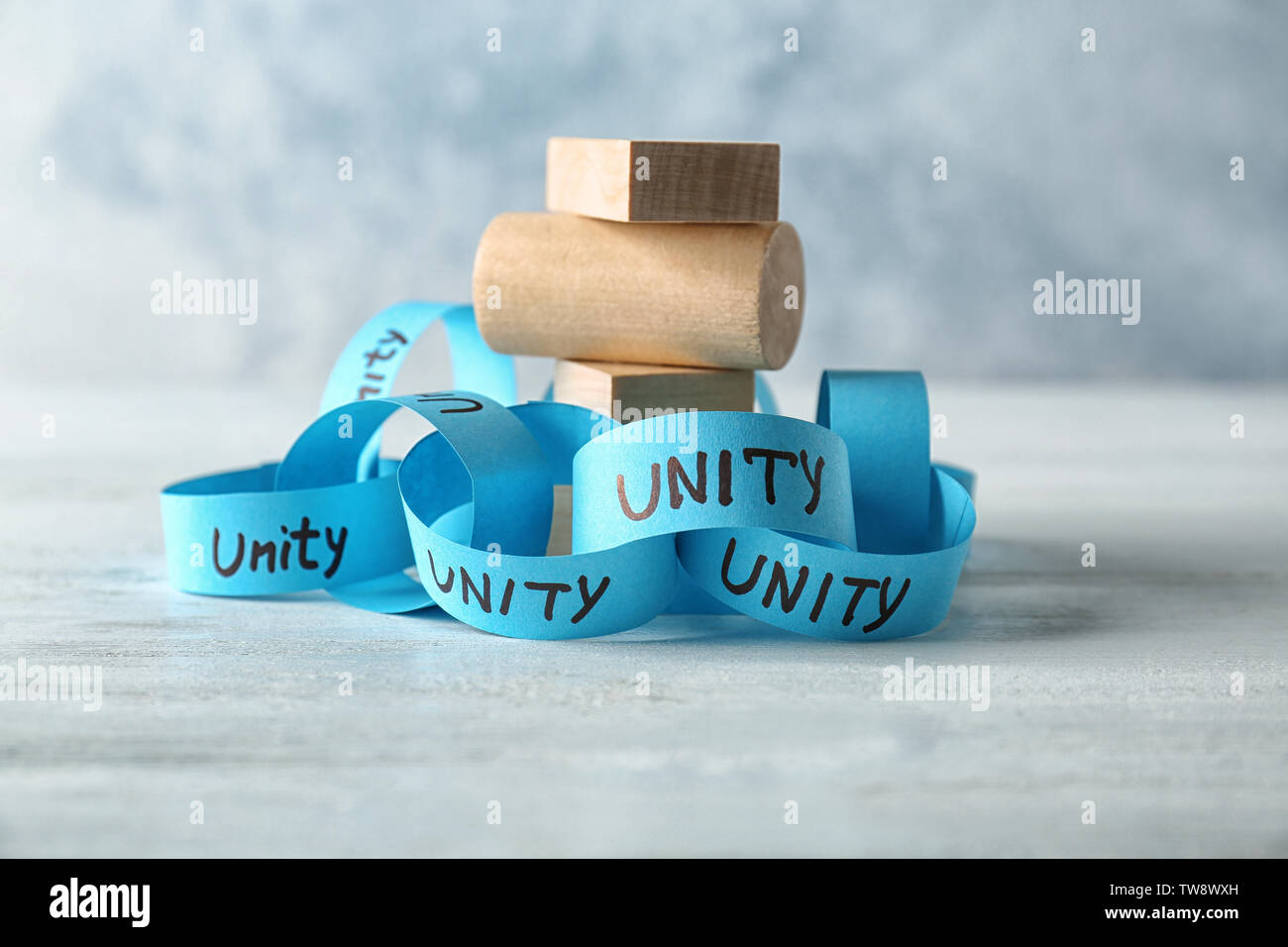 Paper chain with word UNITY on light background Stock Photo - Alamy