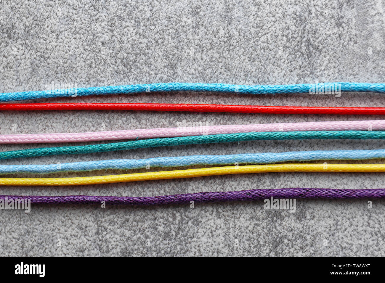 Color strings on grey background. Unity concept Stock Photo - Alamy
