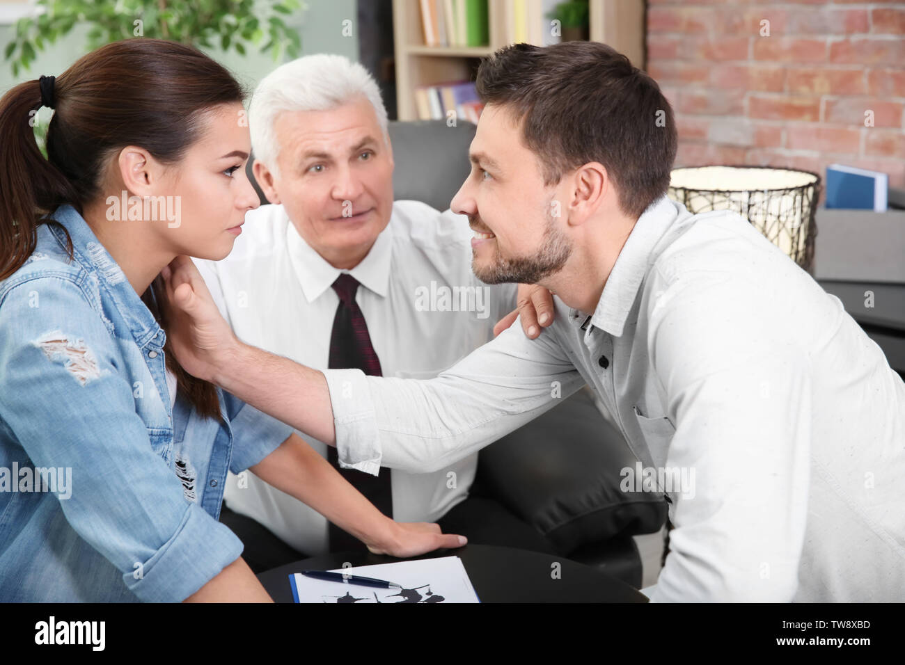 Family psychologist working with young couple in office Stock Photo - Alamy
