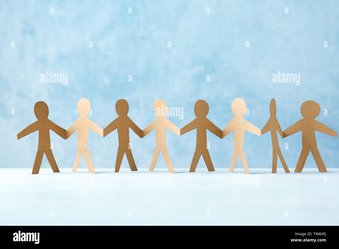 Paper people on light background. Unity concept Stock Photo - Alamy