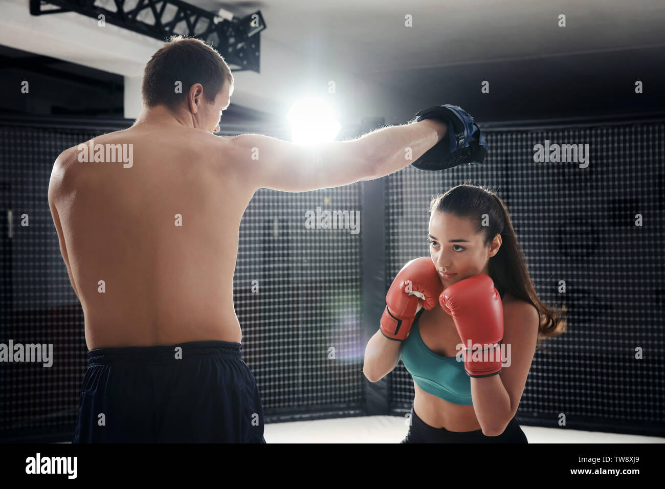 Young female boxer training in gym with personal coach Stock Photo - Alamy