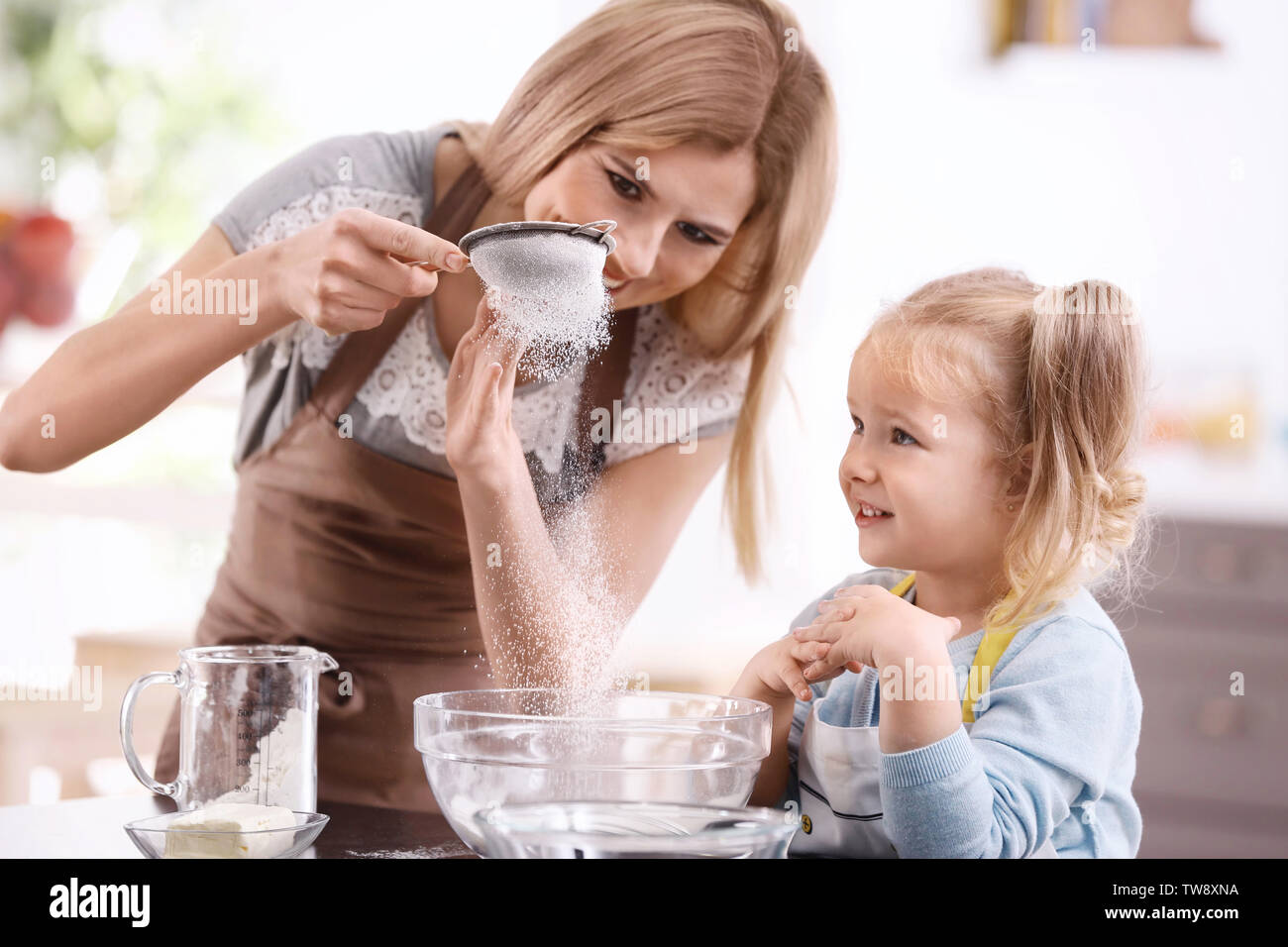 Mother and daughter preparing dough indoors Stock Photo - Alamy