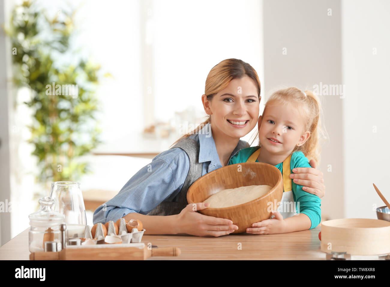 Mother and daughter preparing dough indoors Stock Photo - Alamy