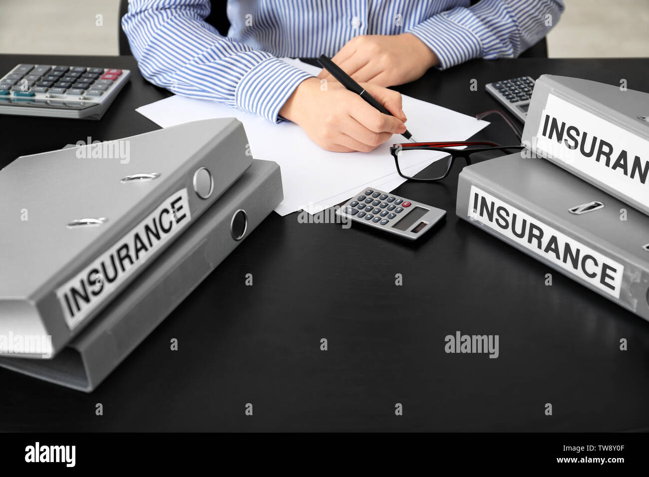 Female insurance agent at workplace Stock Photo - Alamy