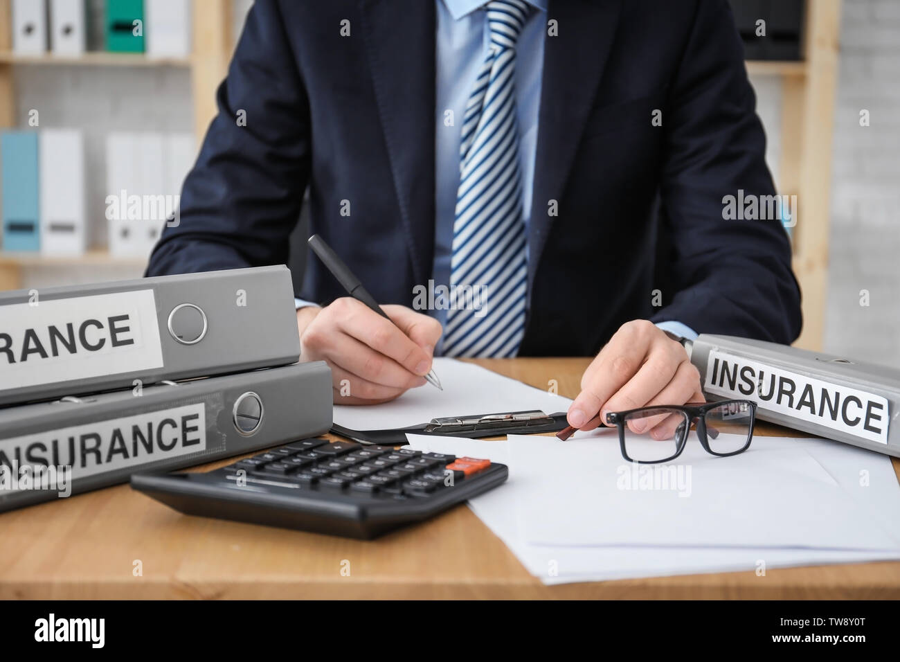 Male insurance agent at workplace Stock Photo - Alamy