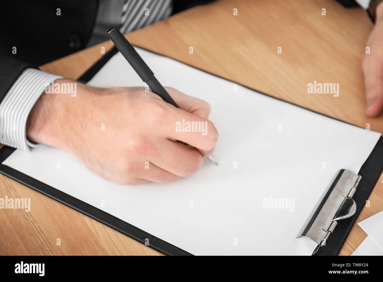 Man writing on sheet of paper, closeup Stock Photo - Alamy