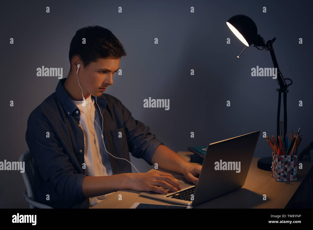 Teenager using computer at night hi-res stock photography and images ...