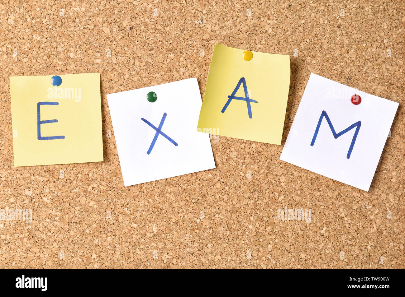 Paper stickers with word EXAM on corkboard Stock Photo - Alamy