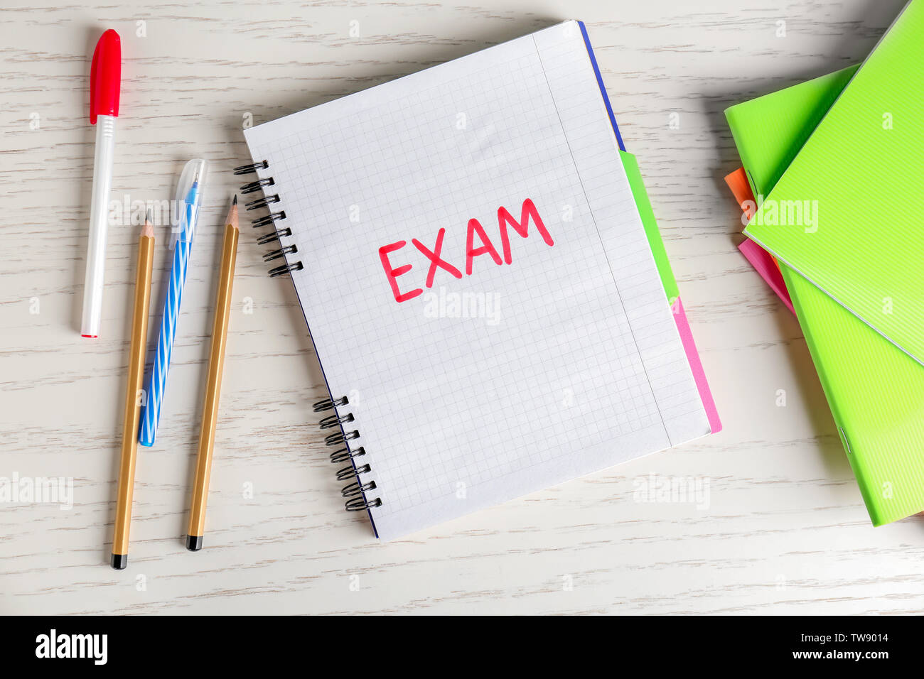 Word EXAM written in notebook on table Stock Photo - Alamy
