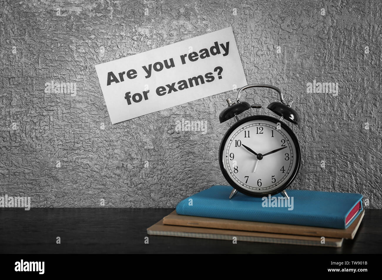 Paper with question "Are you ready for exams?" and notebooks on grey ...