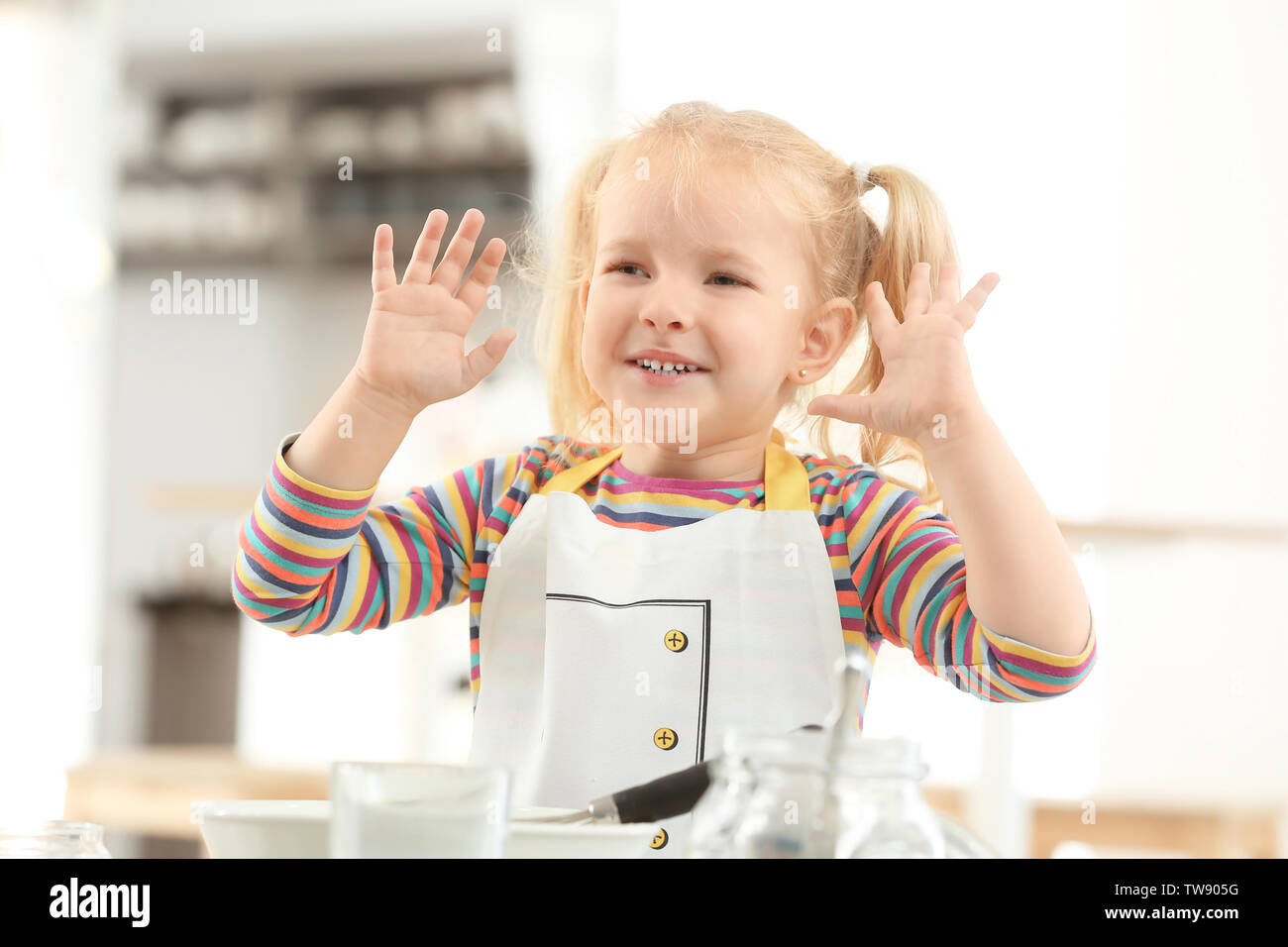 Adorable little girl cooking in kitchen Stock Photo - Alamy