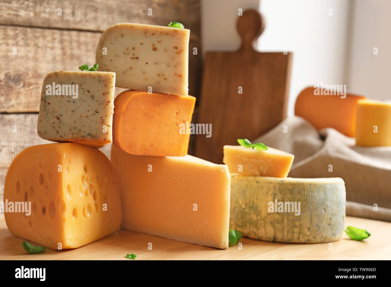 Different kinds of delicious cheese on table Stock Photo - Alamy