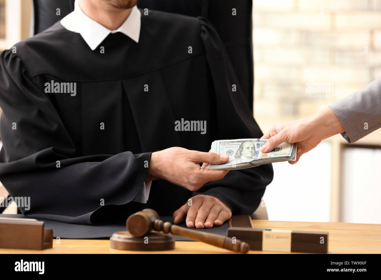 Male judge taking bribe from woman, closeup Stock Photo - Alamy