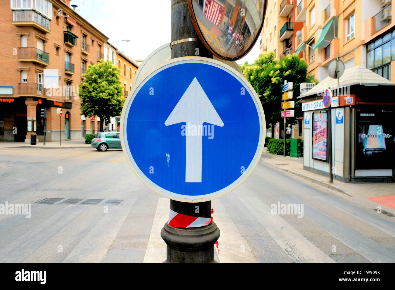 Traffic sign in Spain signaling one-way traffic; white arrow pointing ...