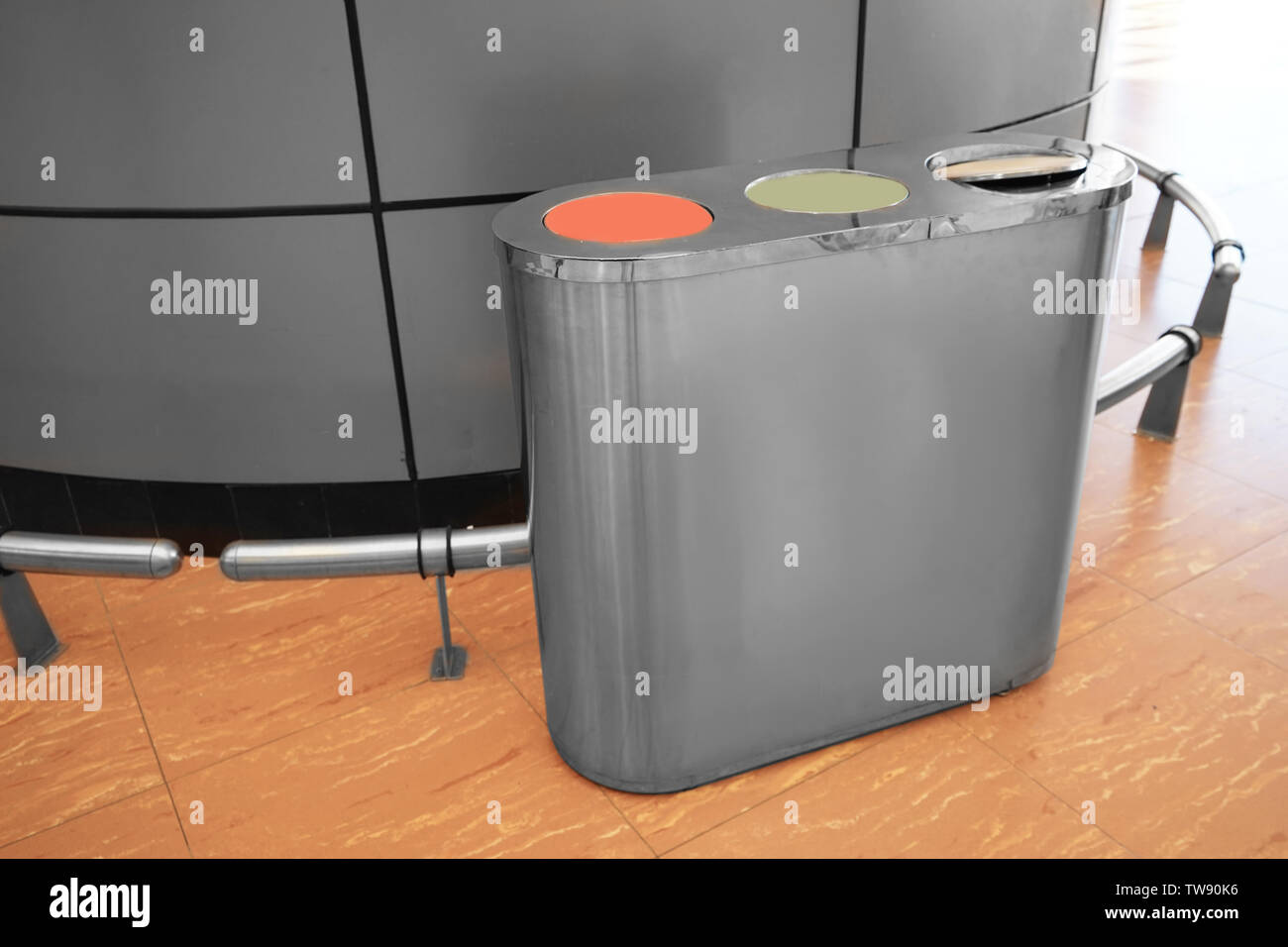 Metal bin with sections for different types of trash indoors. Recycling ...