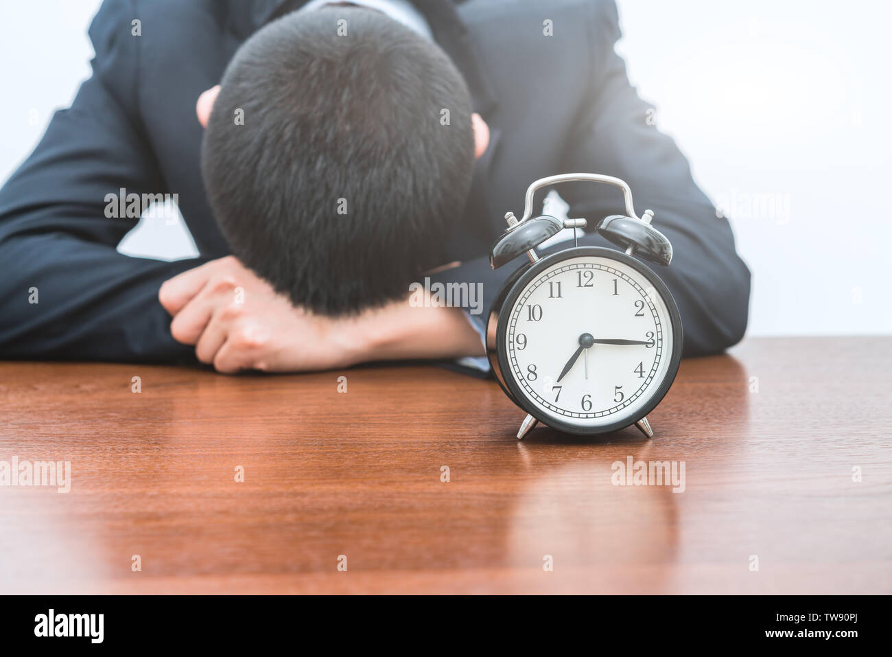 Tired young man lying on the table to rest Stock Photo - Alamy