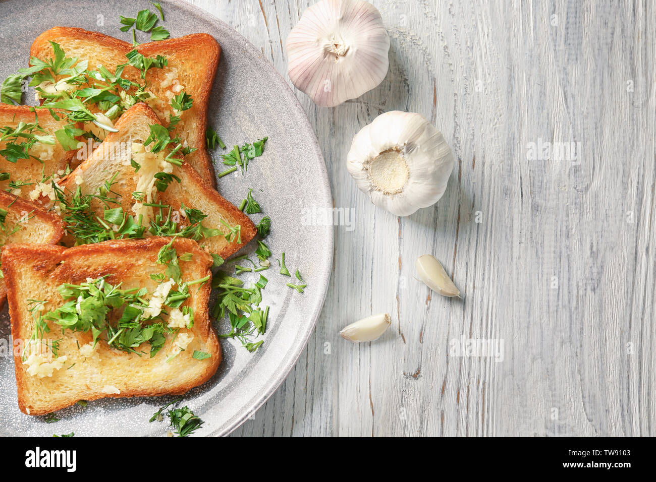 Plate with delicious homemade garlic bread on table Stock Photo - Alamy
