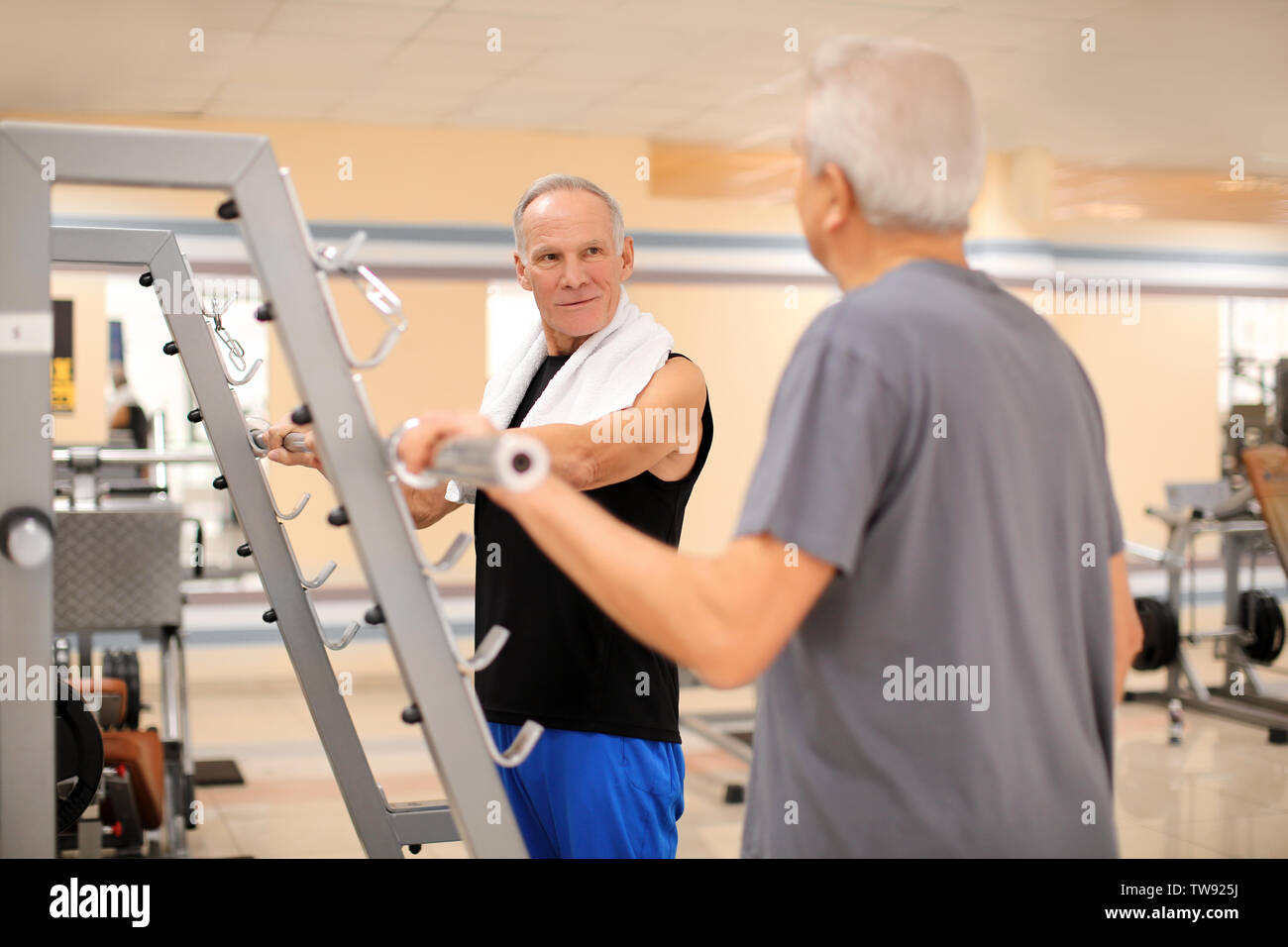 Elderly people in modern gym Stock Photo - Alamy
