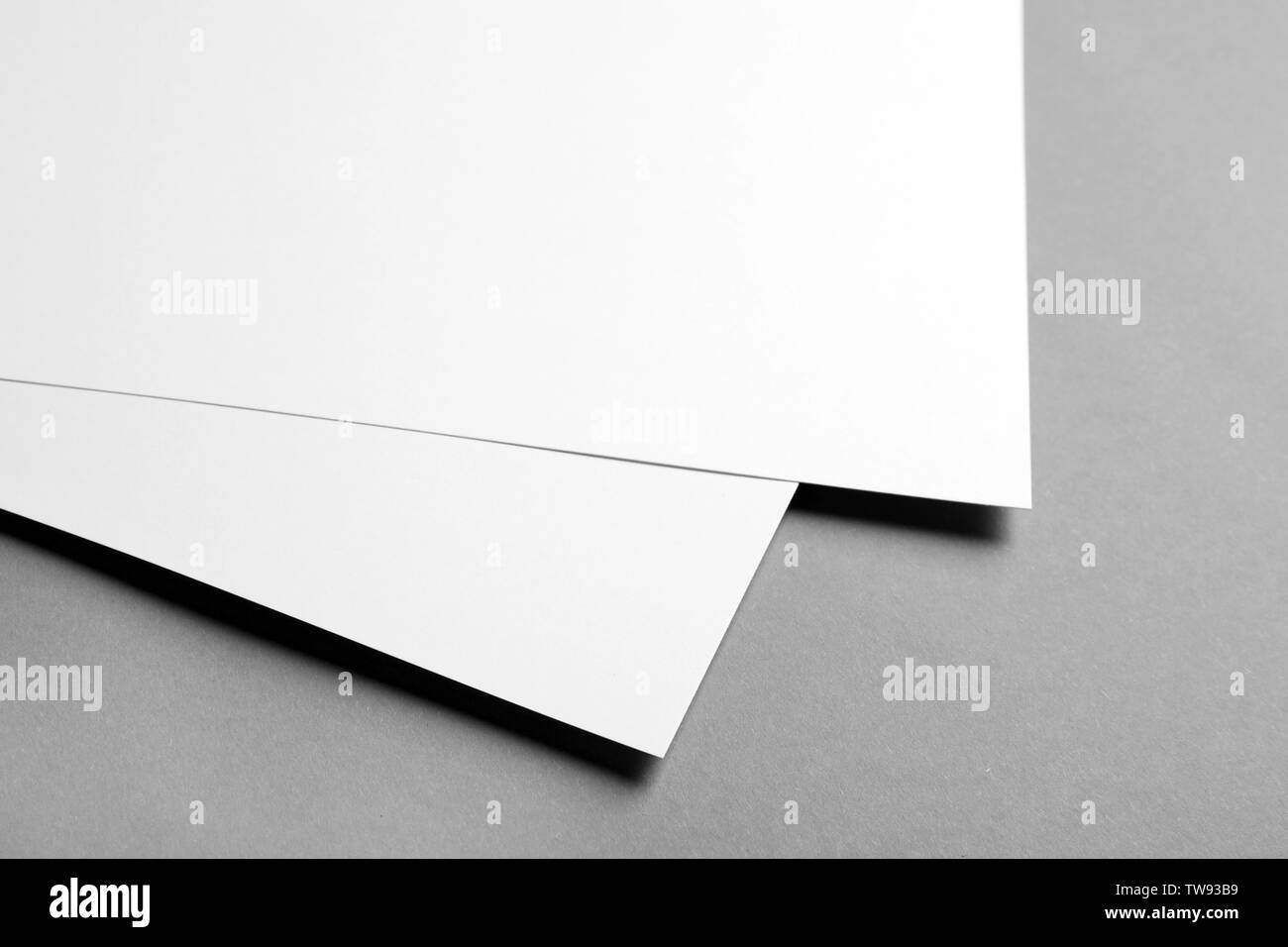Blank sheets of paper on grey background. Mock up for design Stock ...