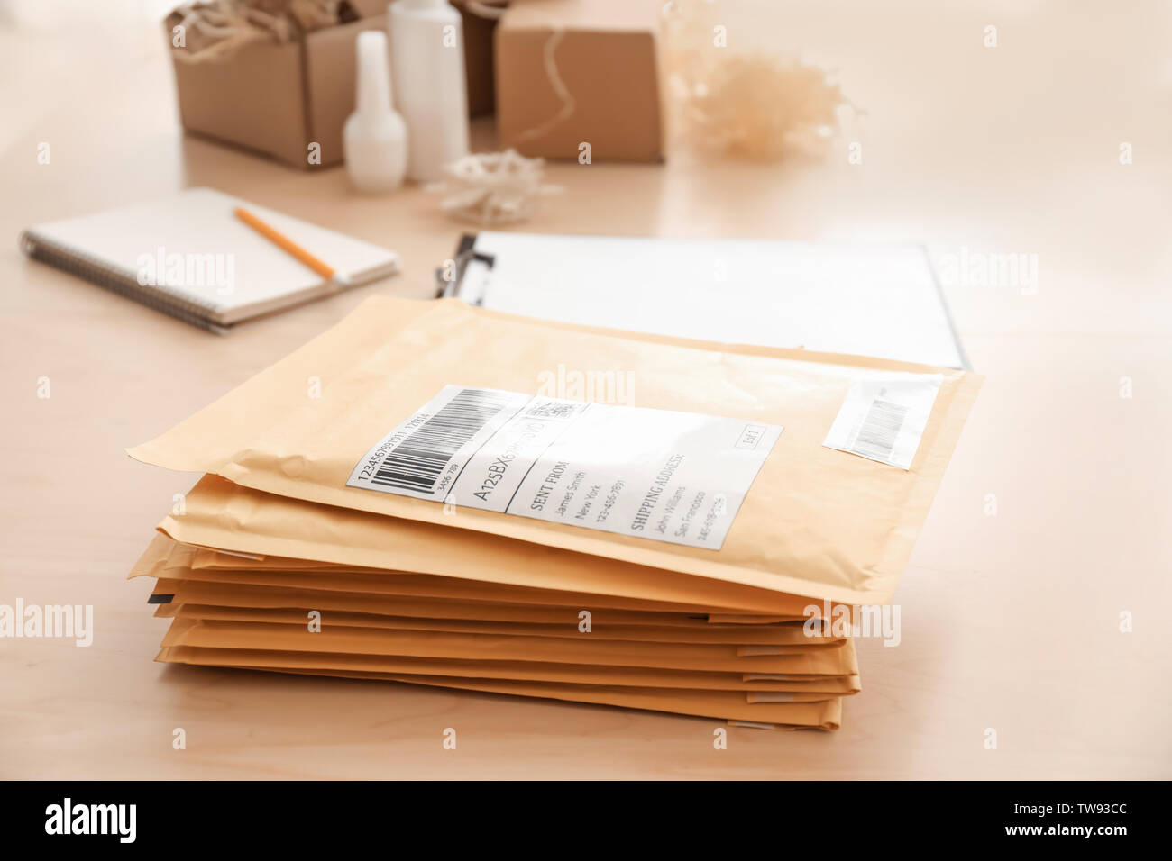 Preparing parcels for shipment to customer on table Stock Photo - Alamy