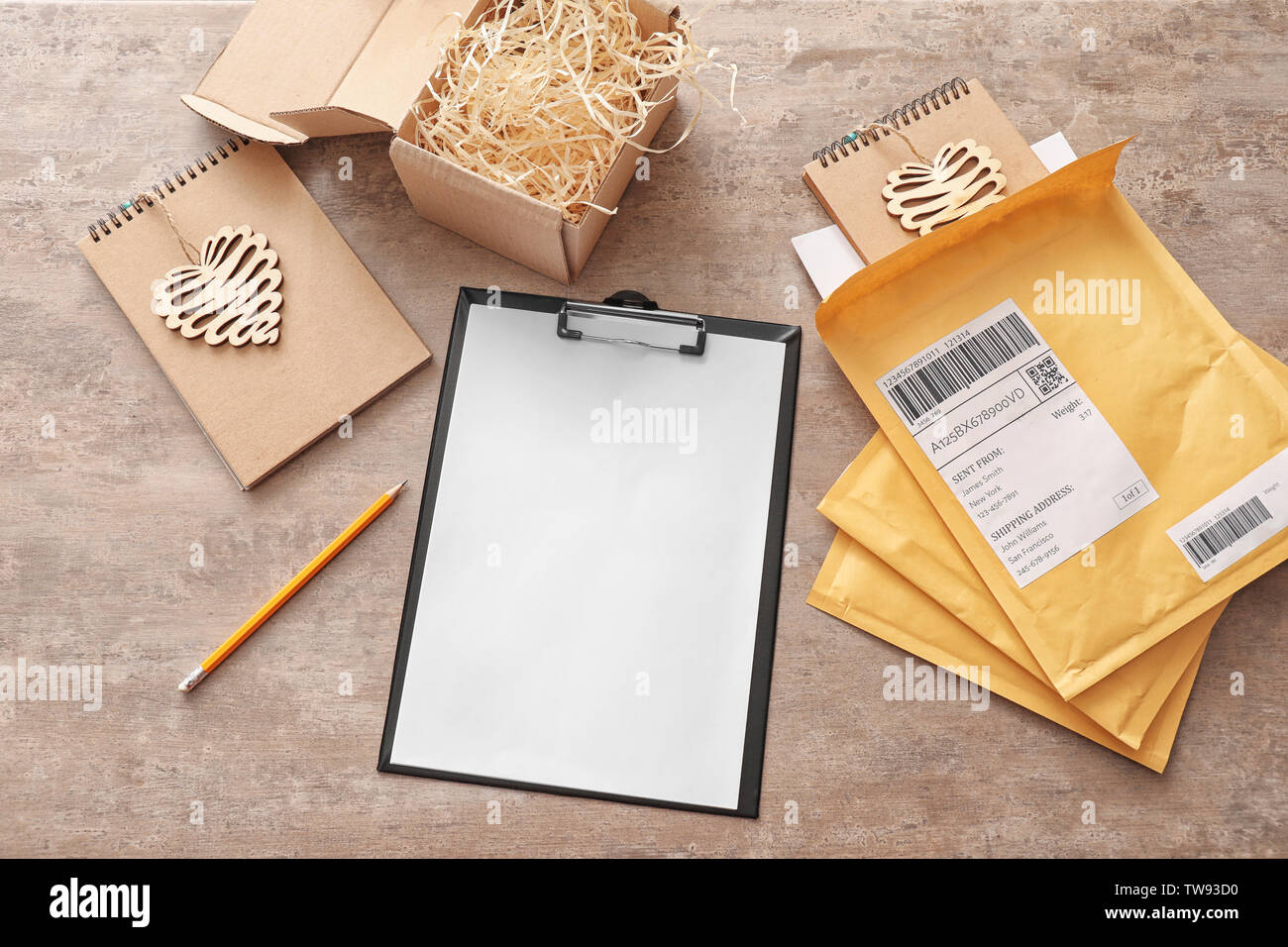Preparing parcels for shipment to customer on table Stock Photo - Alamy