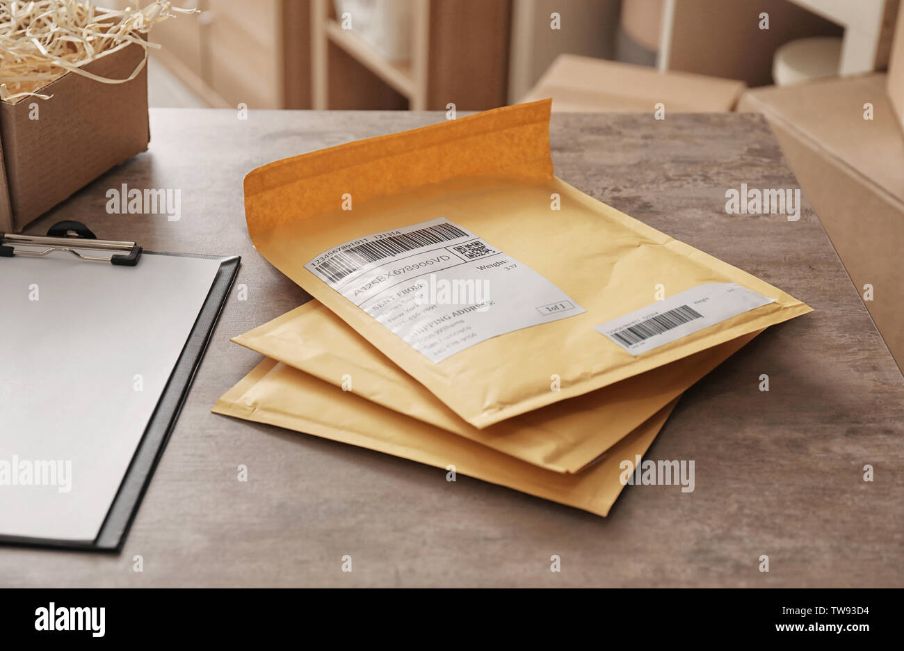 Preparing parcels for shipment to customer on table Stock Photo - Alamy