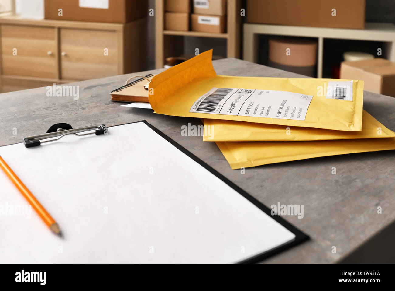 Preparing parcels for shipment to customer on table Stock Photo - Alamy