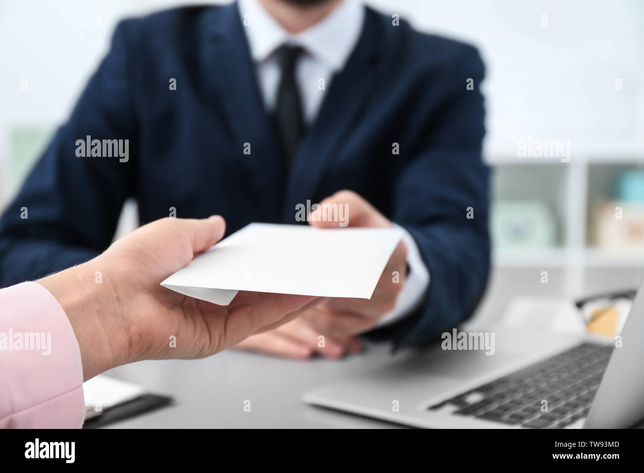 Businessman taking envelope with bribe from woman indoors, closeup ...