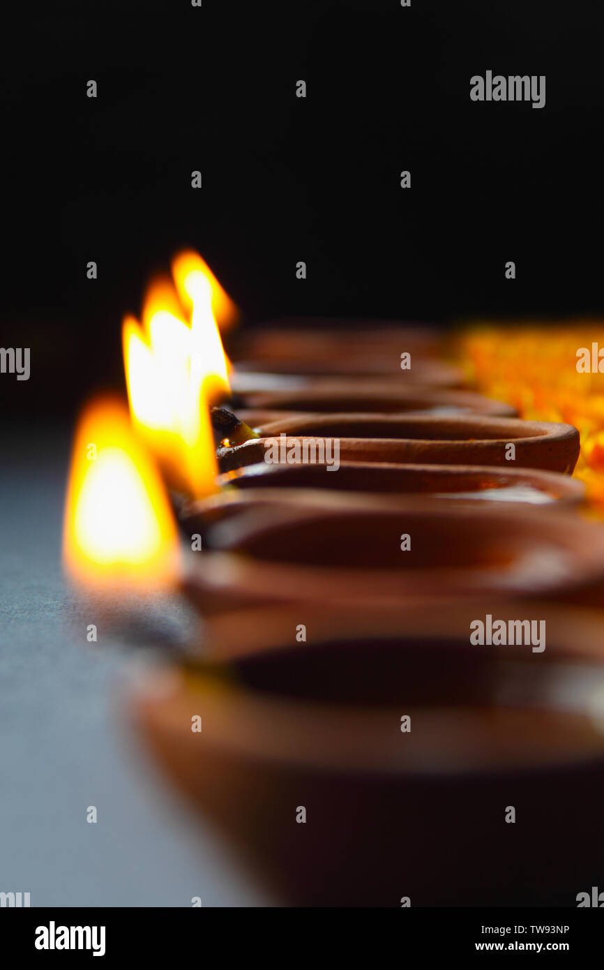Diwali diyas burning in a row Stock Photo - Alamy