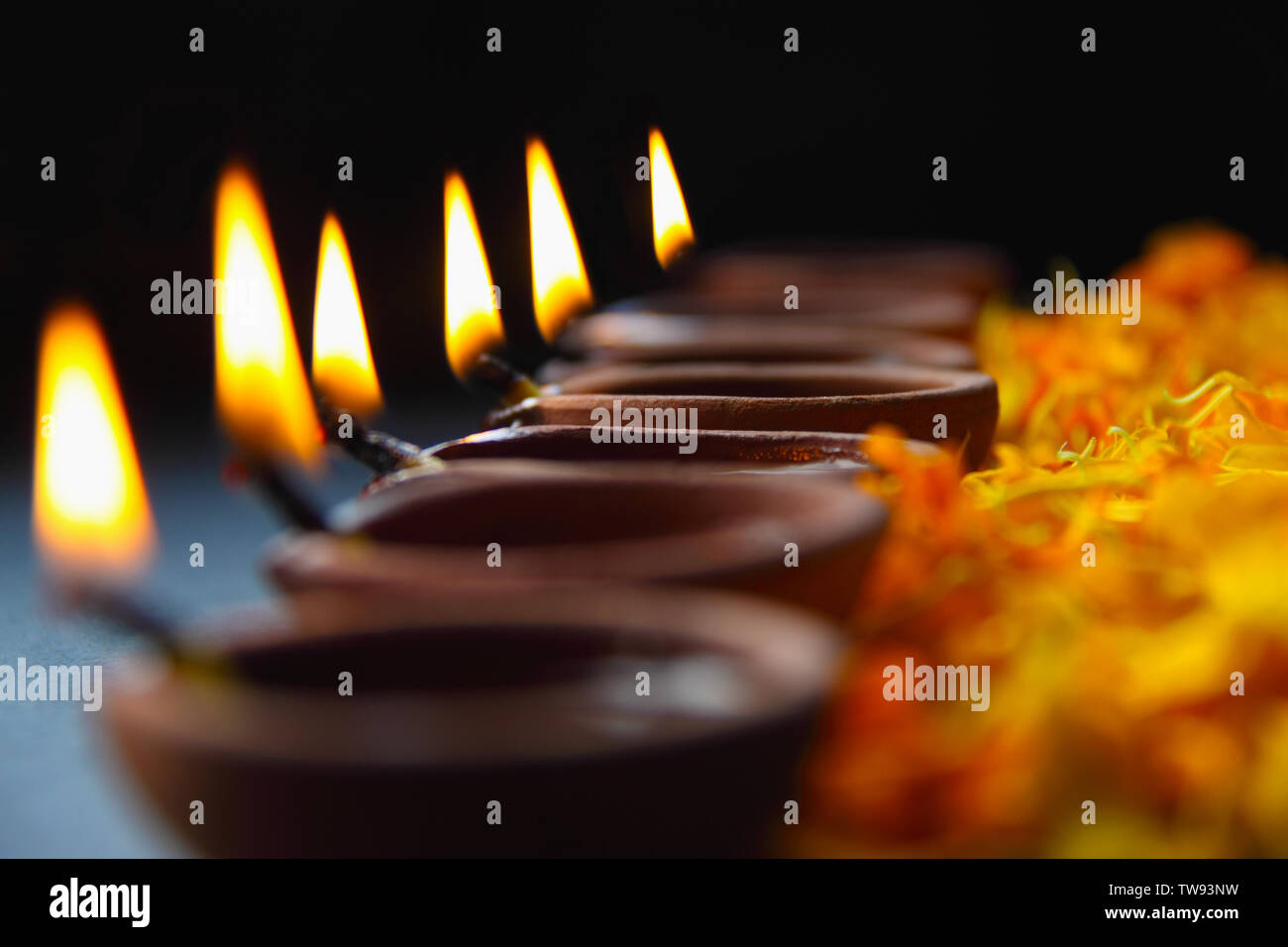 Diwali diyas burning in a row Stock Photo - Alamy