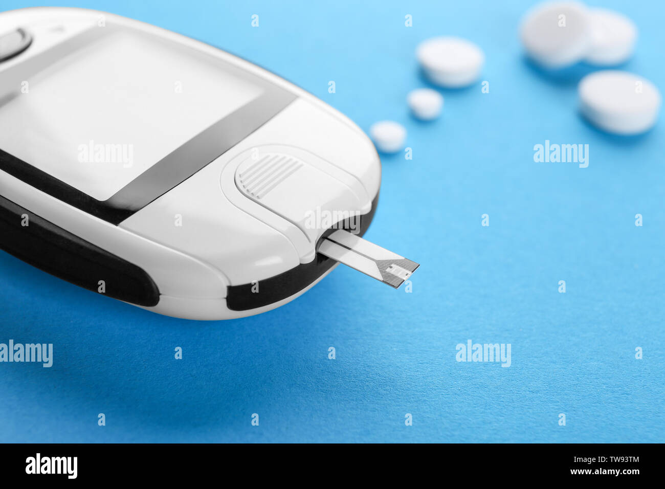 Digital glucometer on color background, closeup. Diabetes management ...