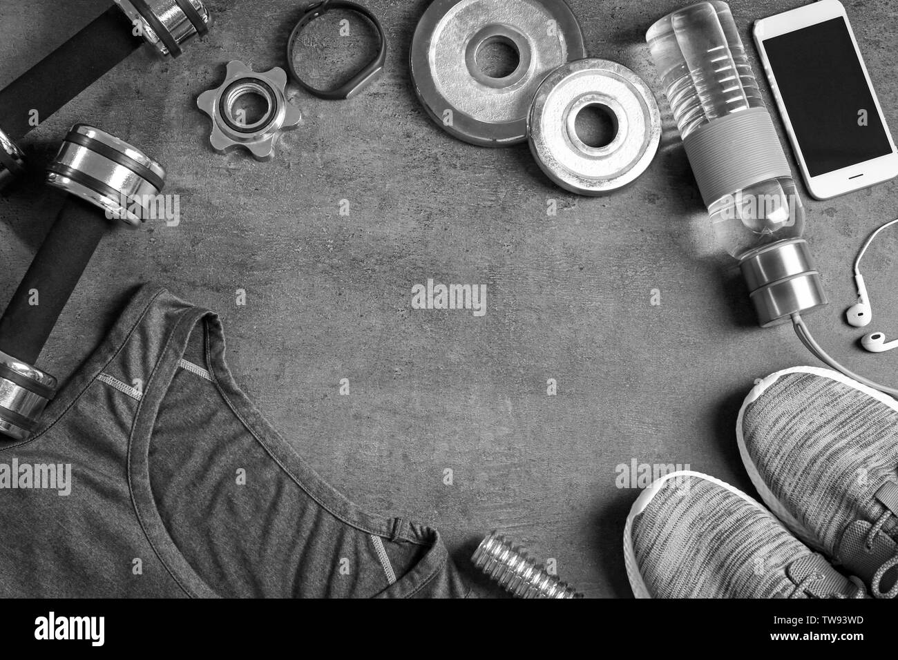 Gym stuff, mobile phone and blank space for exercise plan on grey ...