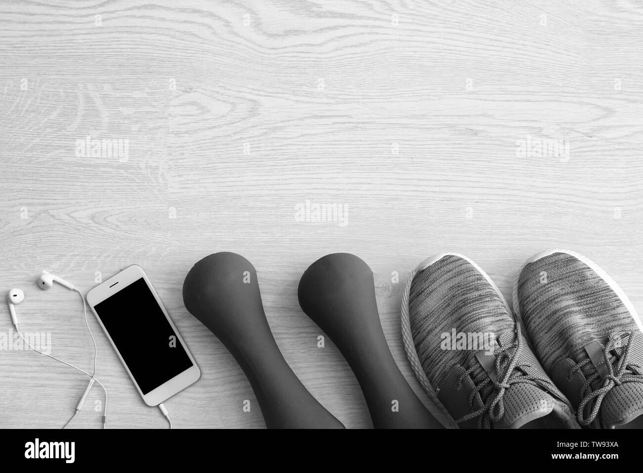 Gym stuff, mobile phone and blank space for exercise plan on wooden ...